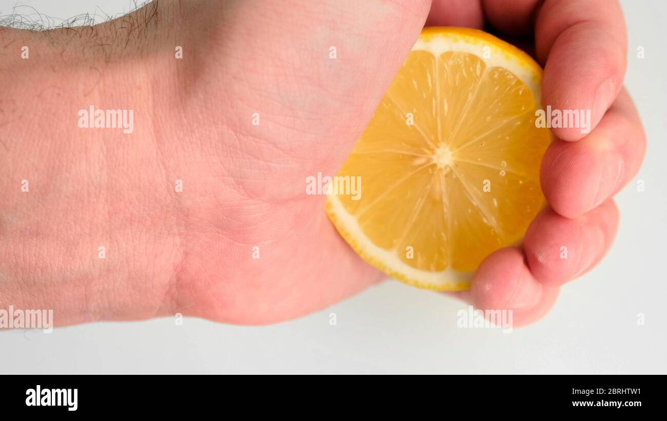 Female hand squeezing juice from fresh lemon. Close up Stock Photo - Alamy