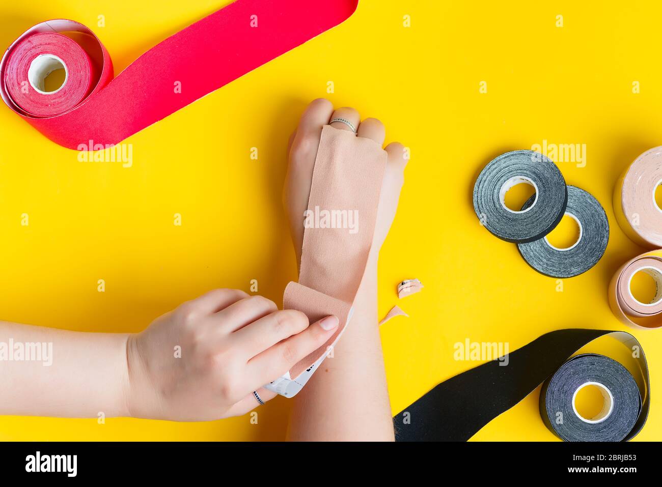 Step by step process kinesiology taping treatment with beige tape on ...