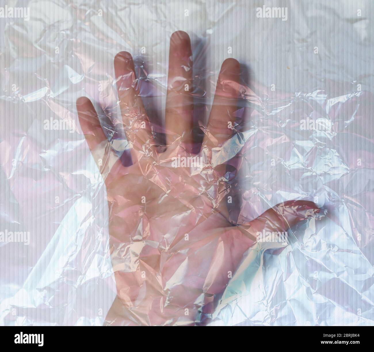 Hand of a young female wrapped in plastic film showing different ...