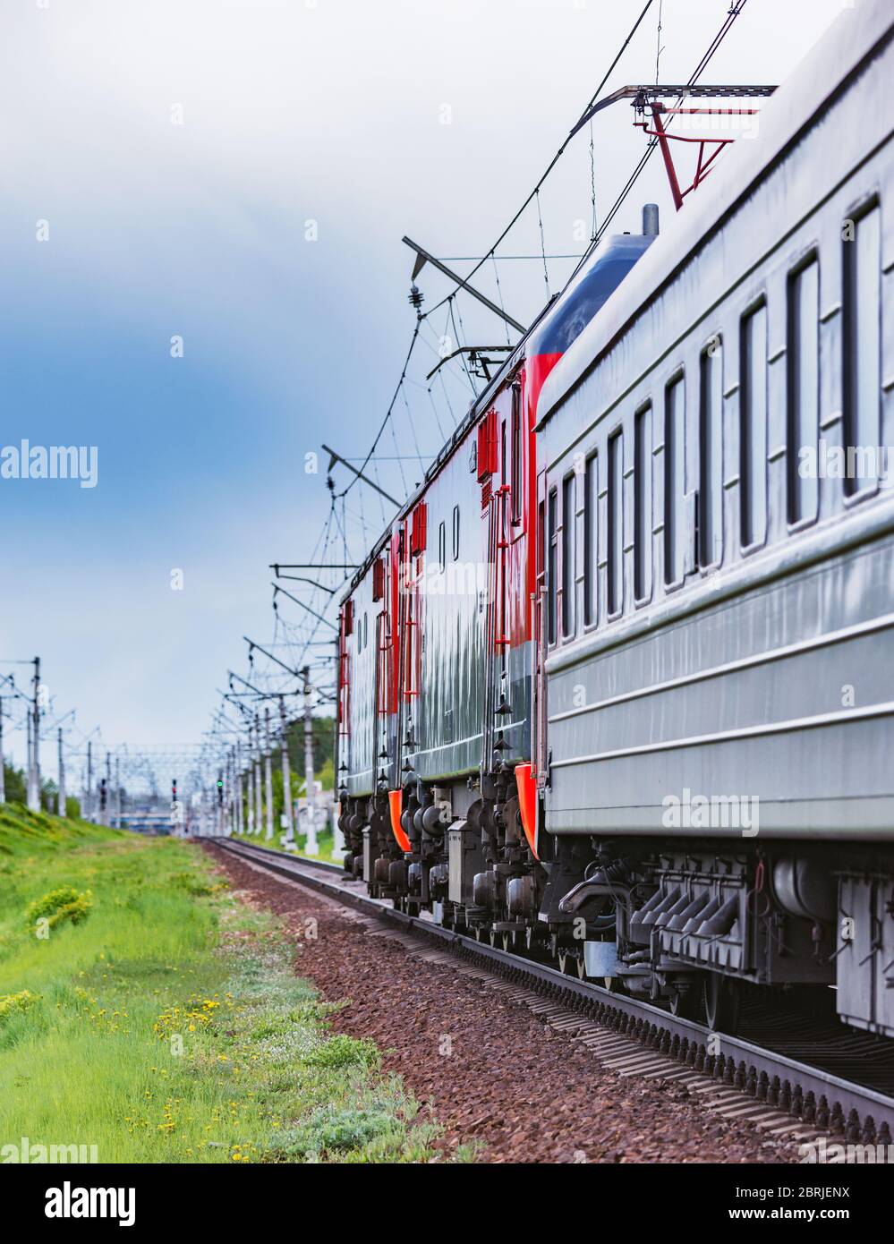 Passenger train approaches to the station Stock Photo - Alamy
