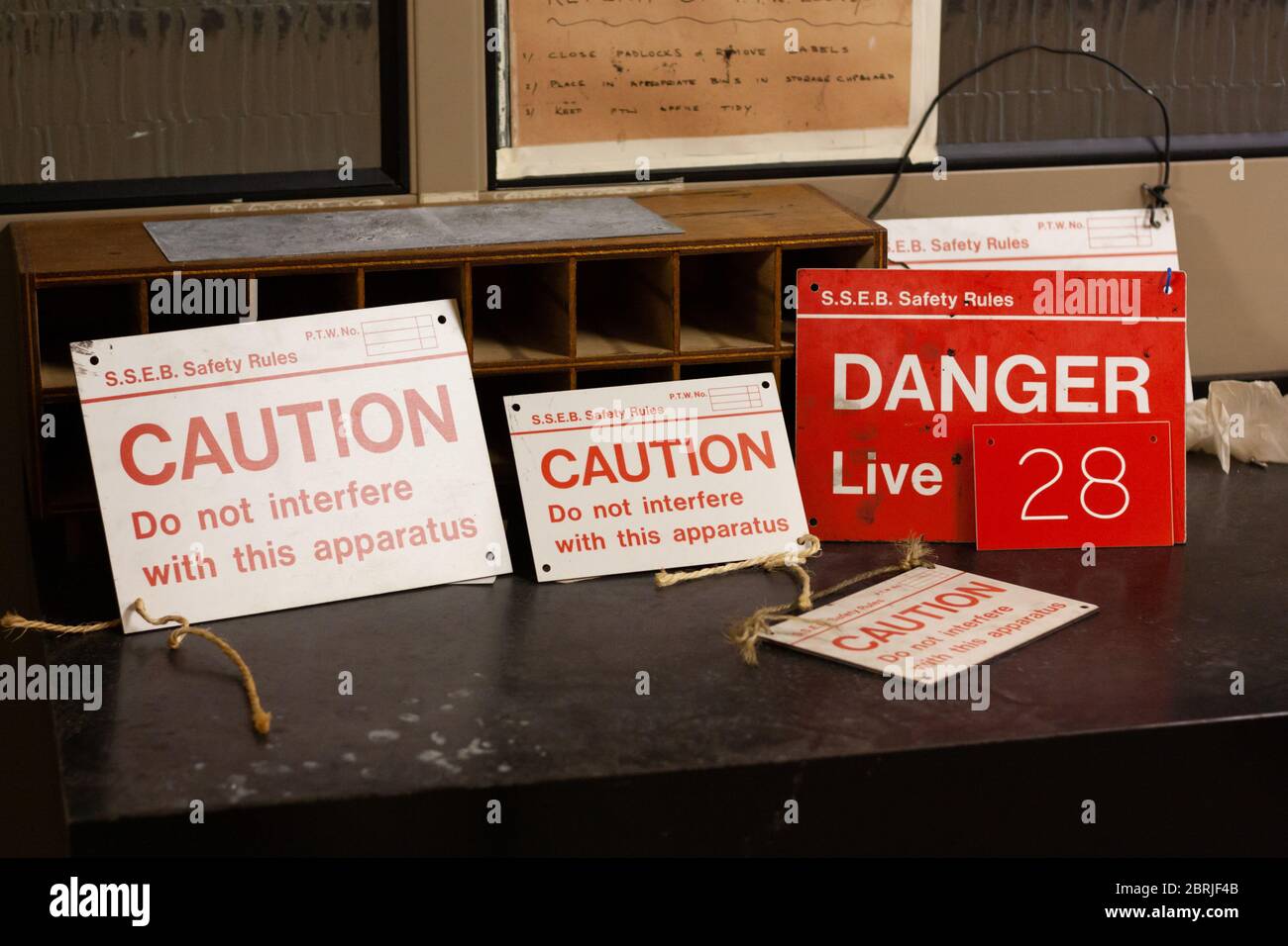 Various warning danger caution signs in an abandoned power station ...
