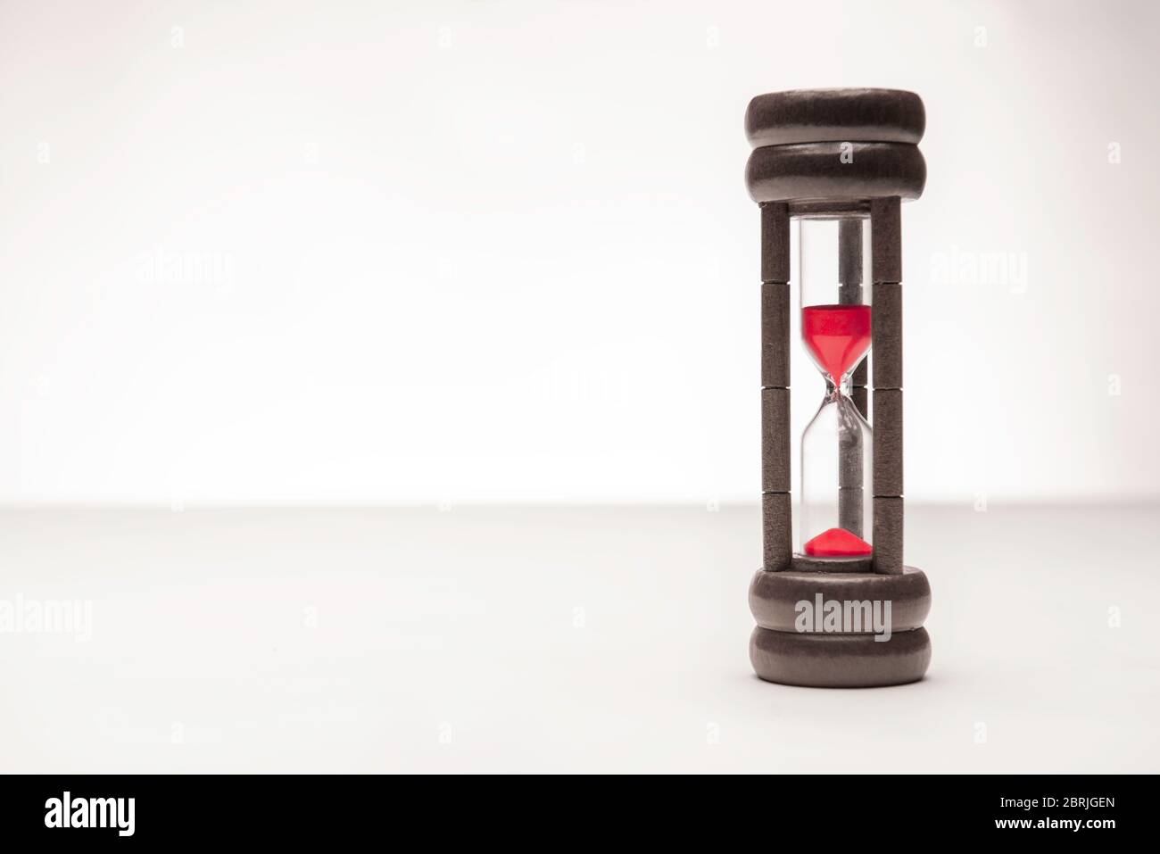 Hour glass with red sand Stock Photo - Alamy