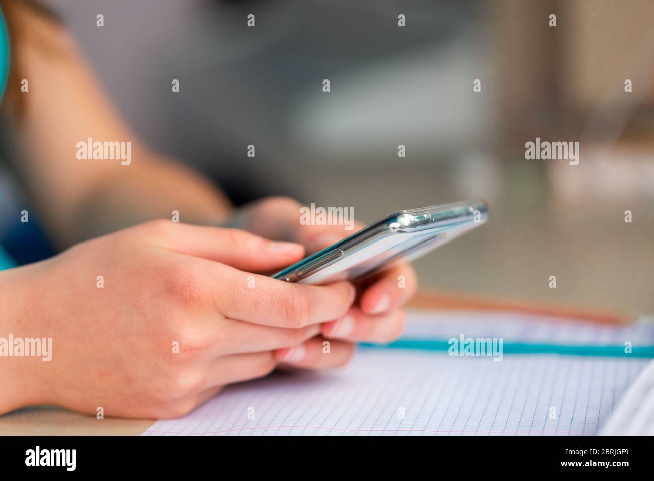 Beautiful young teenage school girl studying at home in her room with ...