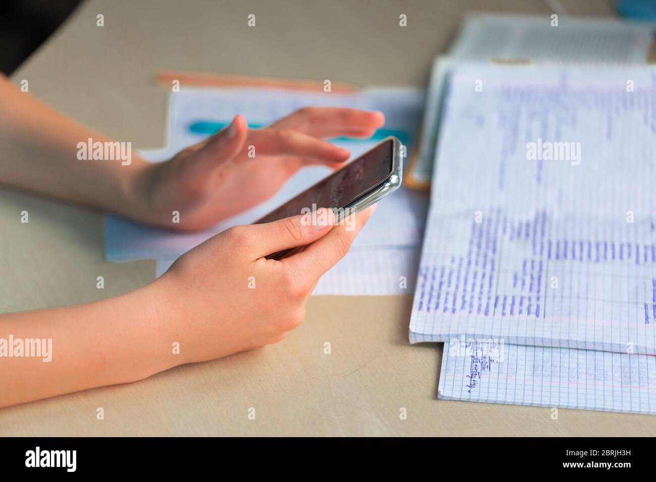 Beautiful young teenage school girl studying at home in her room with ...