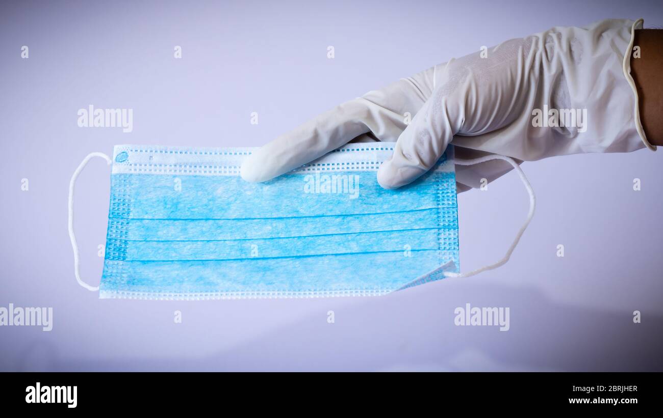 Face mask holding hi-res stock photography and images - Alamy