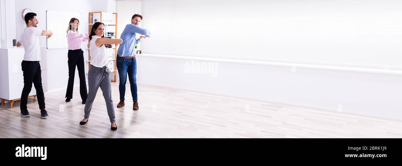 Stretching Exercise At Office. Workers Doing Stretch Workout At ...