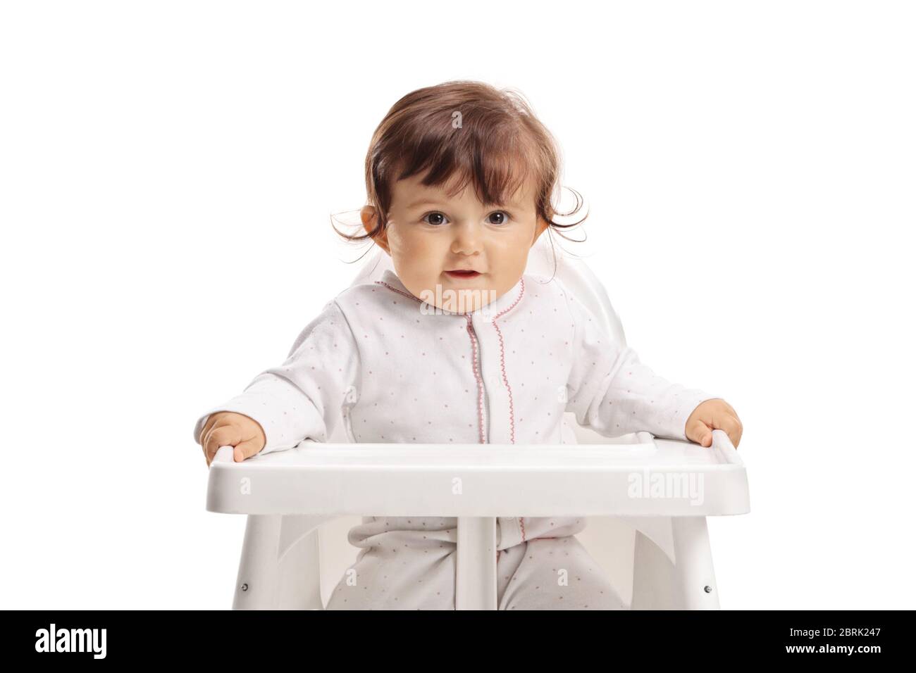 Cute baby girl sitting in a feeding chair isolated on white background ...
