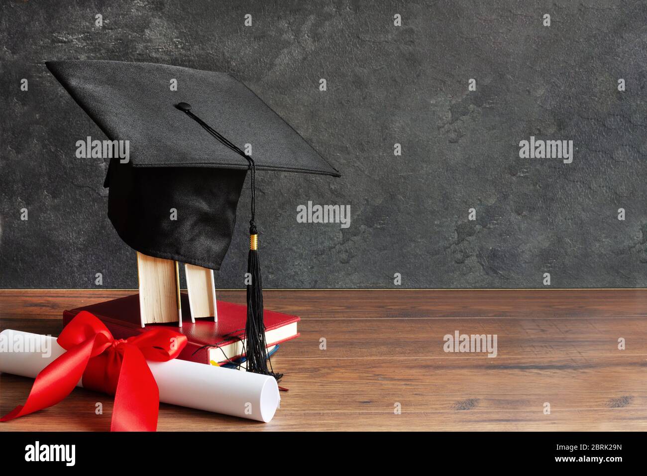 Graduation hat scroll red book hi-res stock photography and images - Alamy