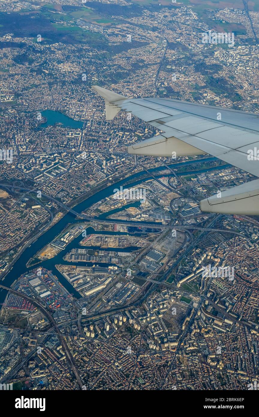 View over the clouds from the porthole of an airplane with plane wing ...