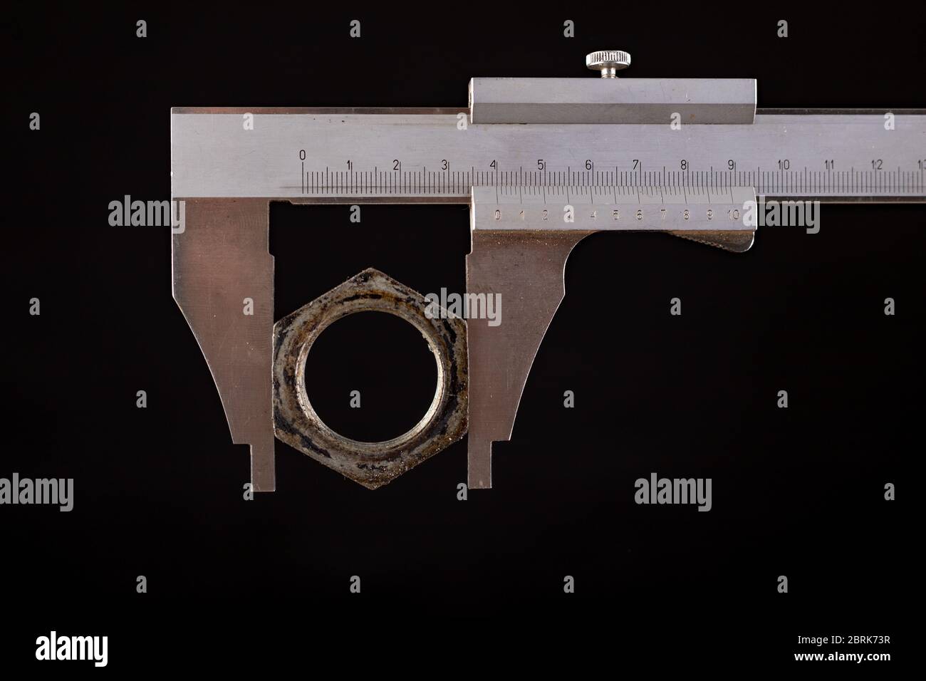 Measuring machine parts with an analog caliper. Measurement work in the ...