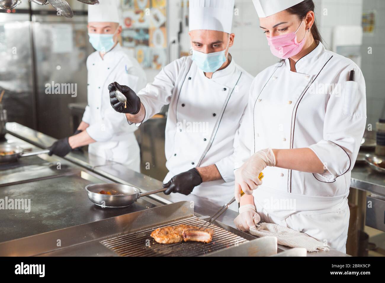 team of cooks cooks in a restaurant Stock Photo - Alamy