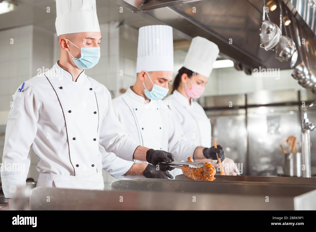 team of cooks cooks in a restaurant Stock Photo - Alamy