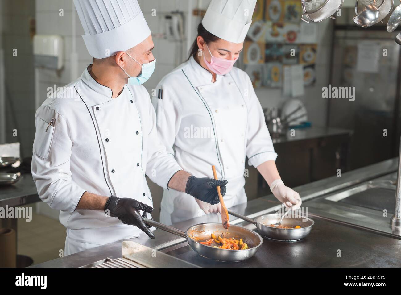 team of cooks cooks in a restaurant Stock Photo - Alamy