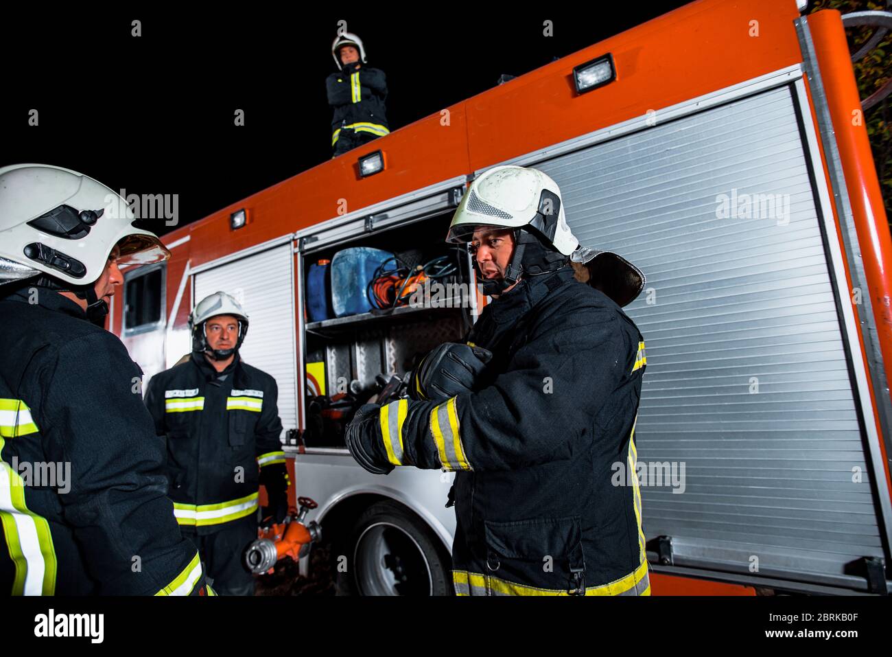 Fire brigade fighting a forest fire with various tools for eliminating ...
