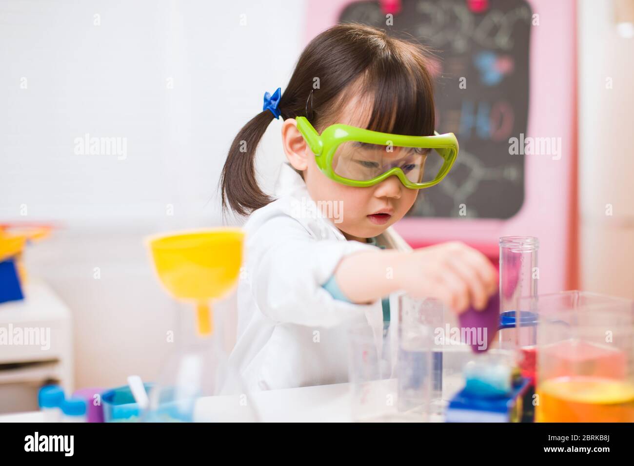 toddler girl pretend play scientist role for homeschooling Stock Photo ...