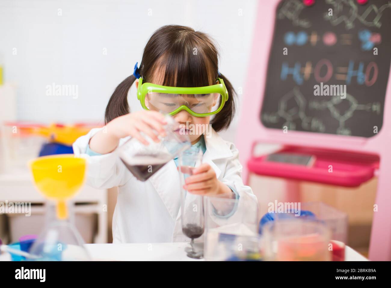 toddler girl pretend play scientist role for homeschooling Stock Photo ...