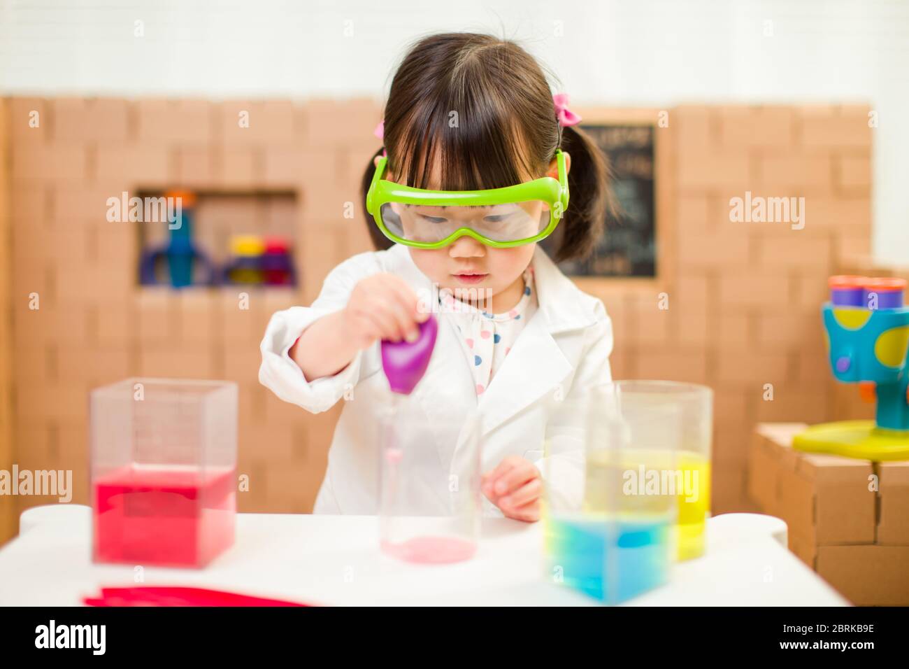 toddler girl pretend play scientist role for homeschooling Stock Photo ...