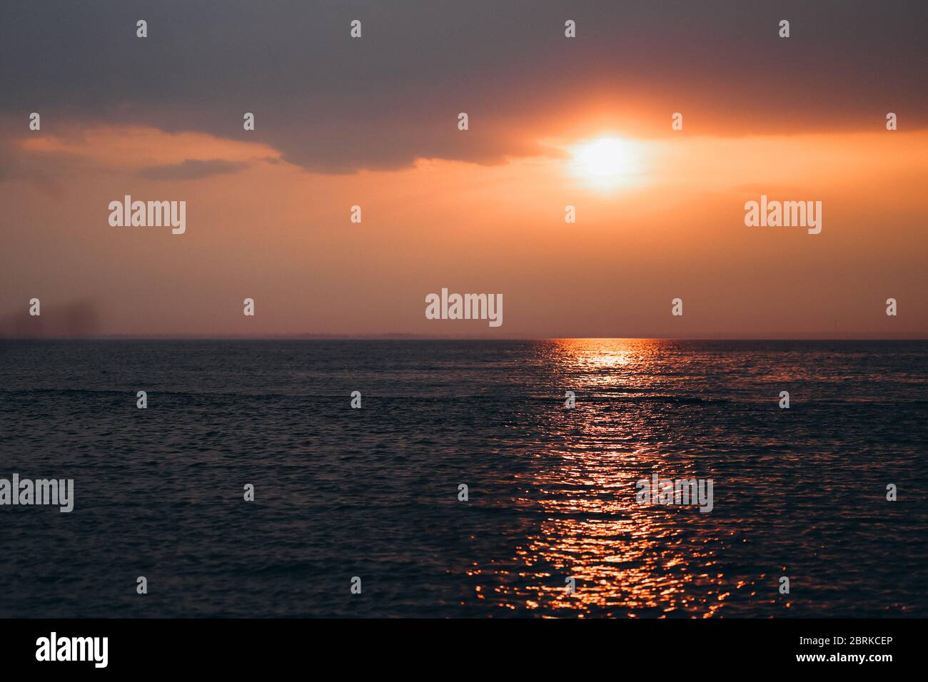 Beautiful orange sunset or sunrise near seaside ocean dark colors Stock ...