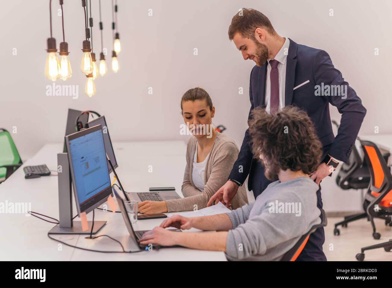 Manager overseeing his employees beautiful blonde and a coworker with ...