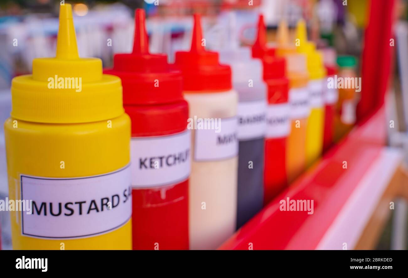 Multiple flavor sauce bottles in a food card at a food festival ready ...