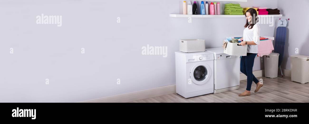 Woman using washing machine hi-res stock photography and images - Alamy