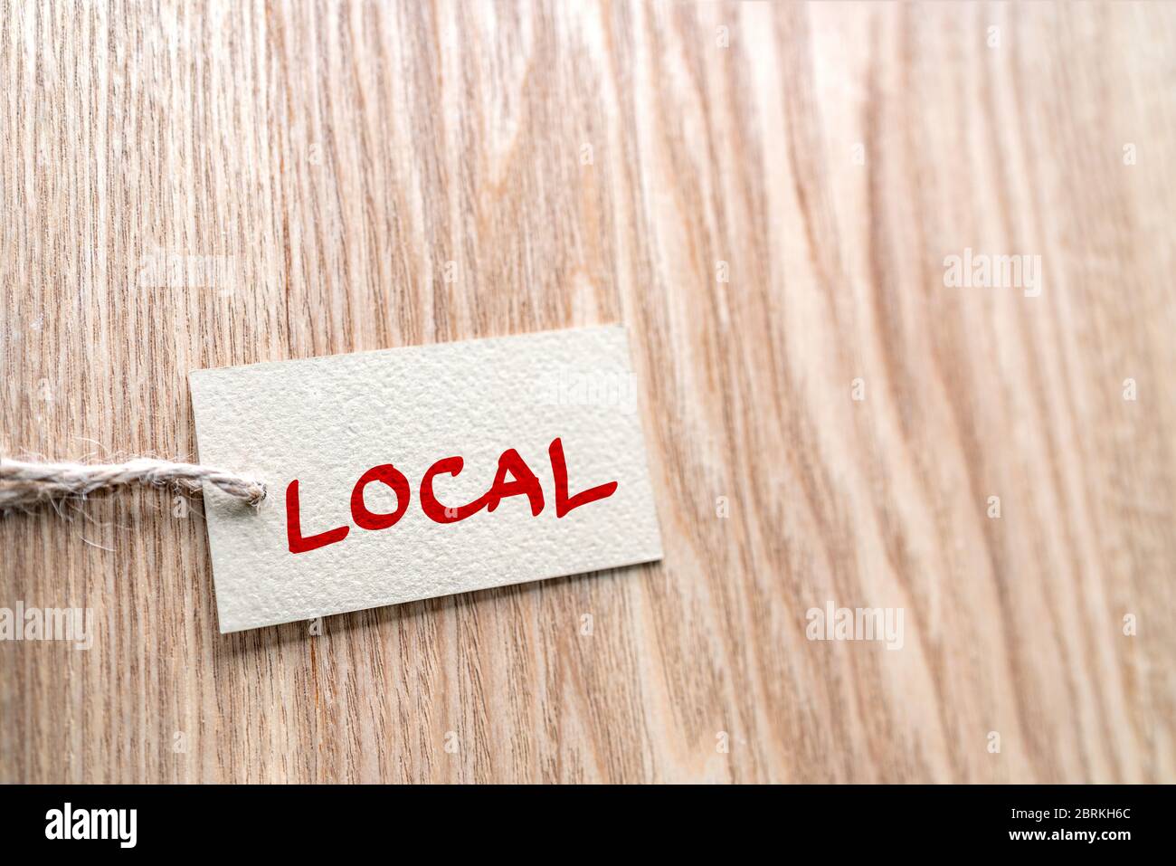 LOCAL handwritten paper gift box label on brown wood texture background ...