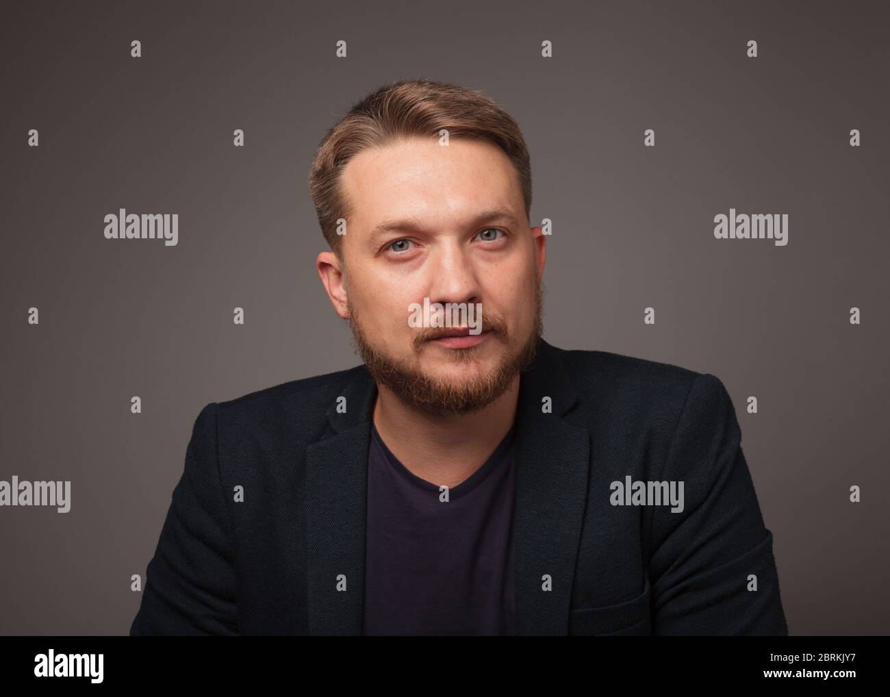 Handsome man over dark background looking at camera Stock Photo - Alamy
