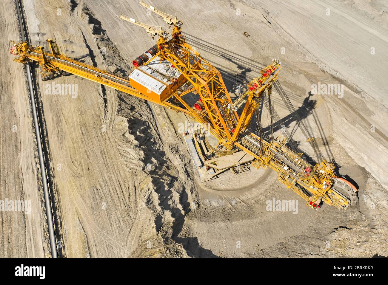 Top view of a bucket wheel excavator mining coal in an open pit mine ...