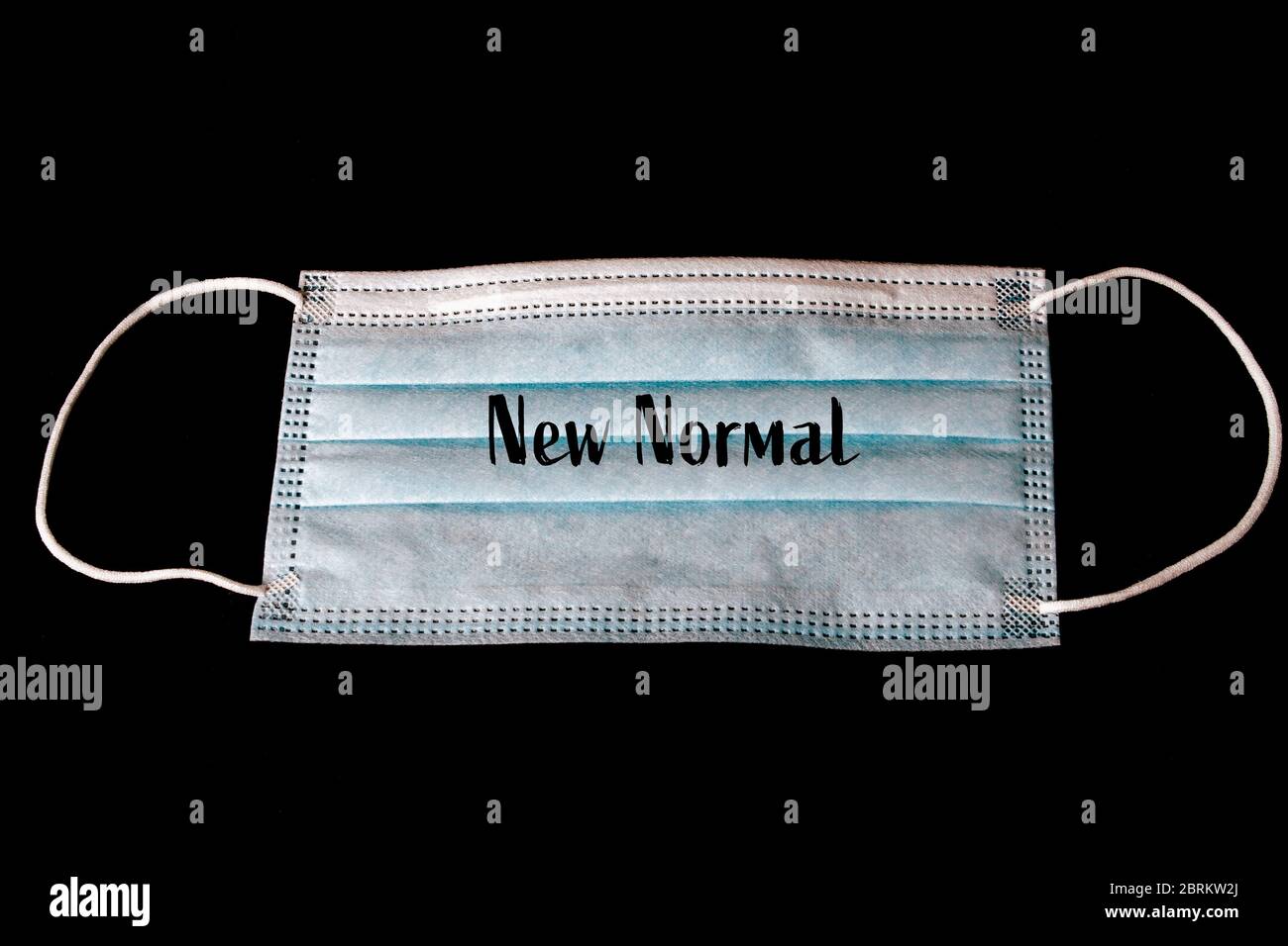 Face protection mask with the words new normal as a concept after the ...