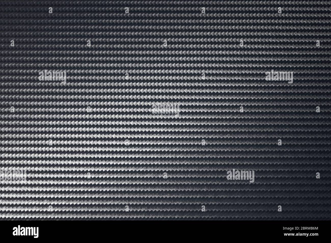 carbon fibre or graphite sheet with background texture beam of light ...