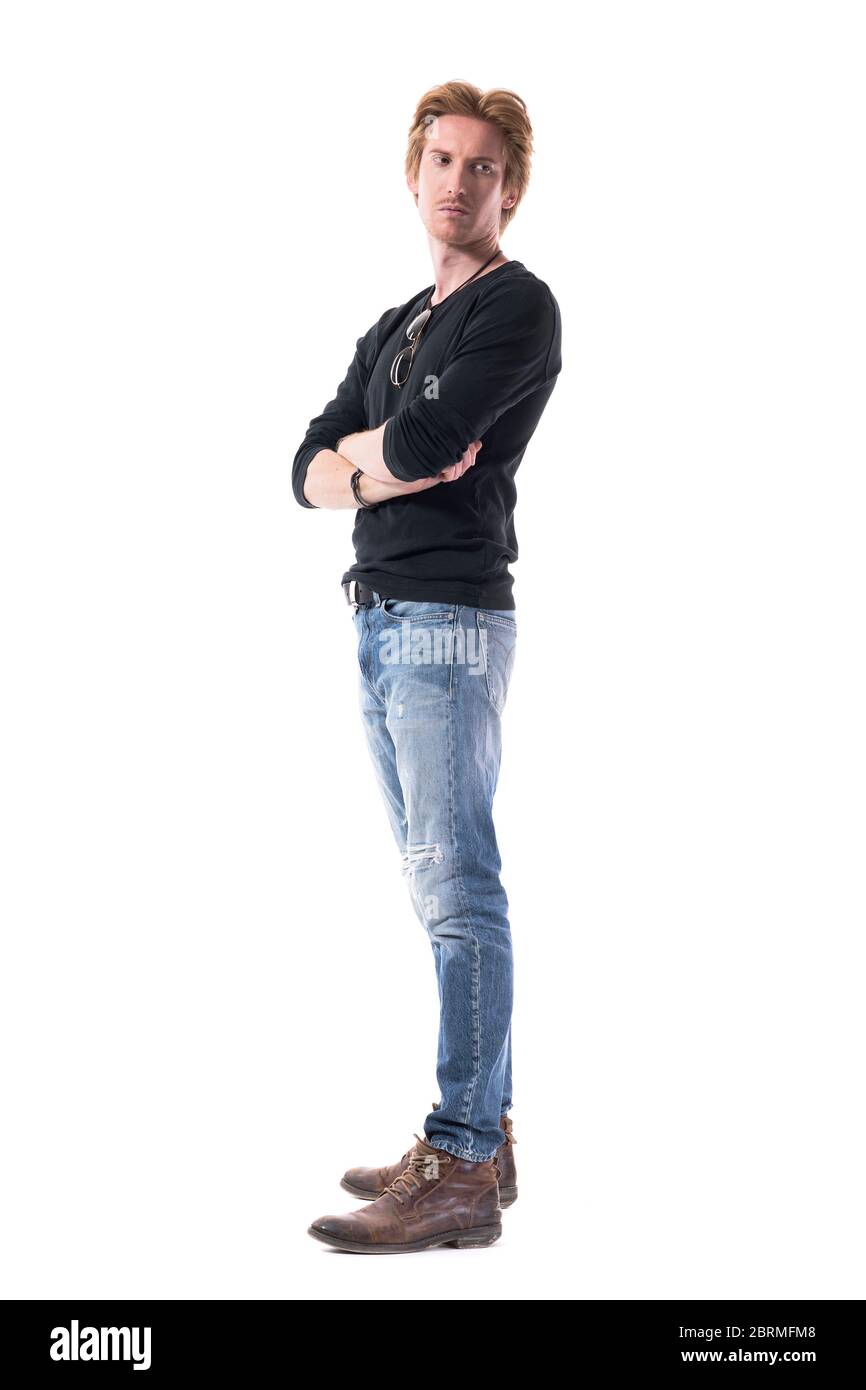Side view of waiting dissatisfied young man in stylish clothes looking ...