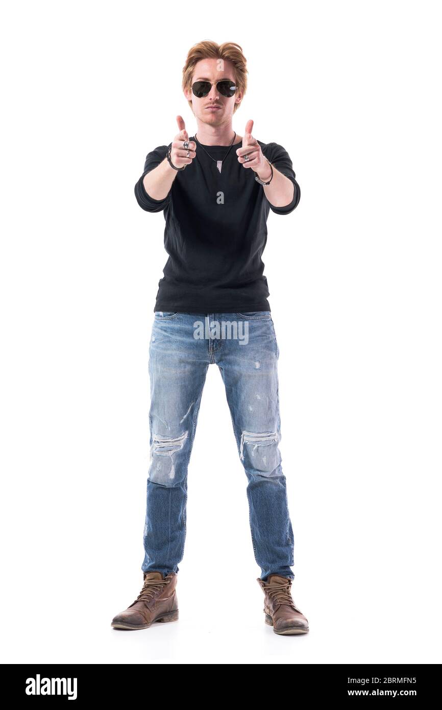 Serious young stylish man pointing finger at camera blaming and ...