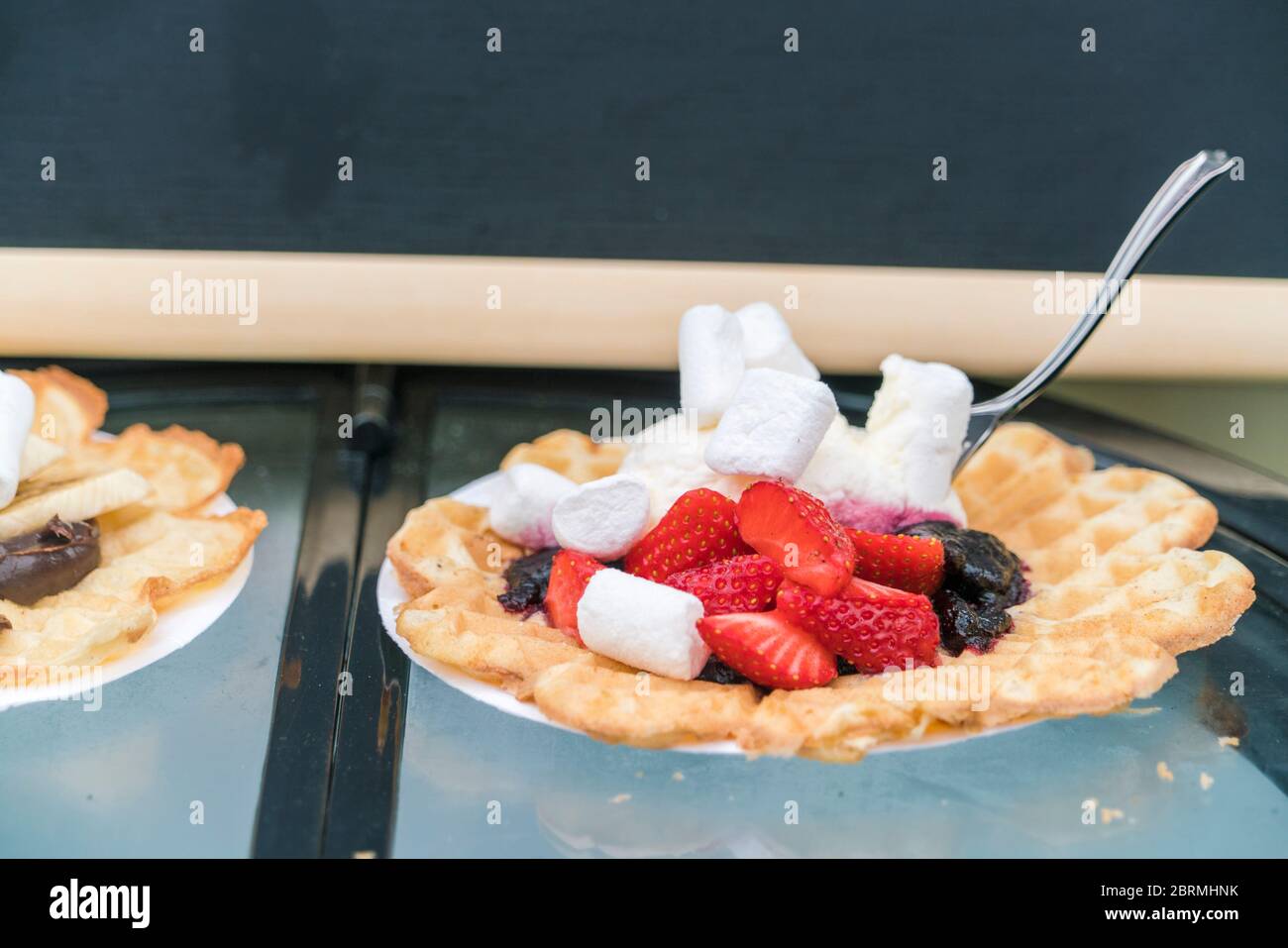 Belgian waffle with strawberry and marchemallow at festival street food ...