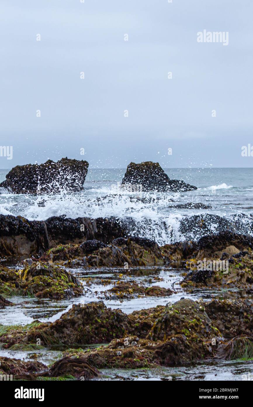 Tidal pools with ocean waves crashing over rocks into pools Stock Photo ...