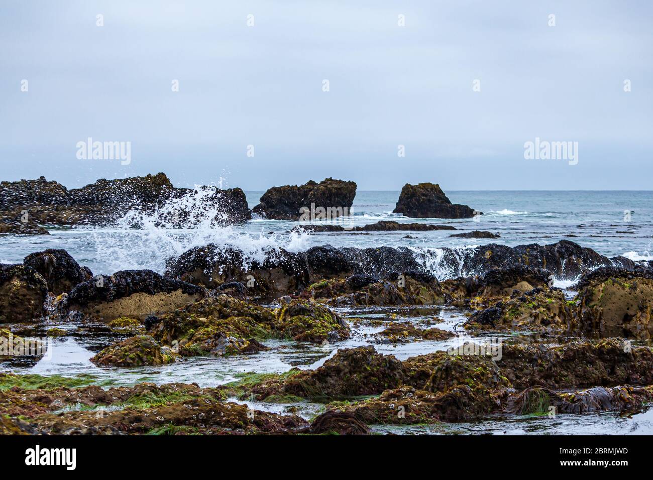 Tidal pools with ocean waves crashing over rocks into pools Stock Photo ...