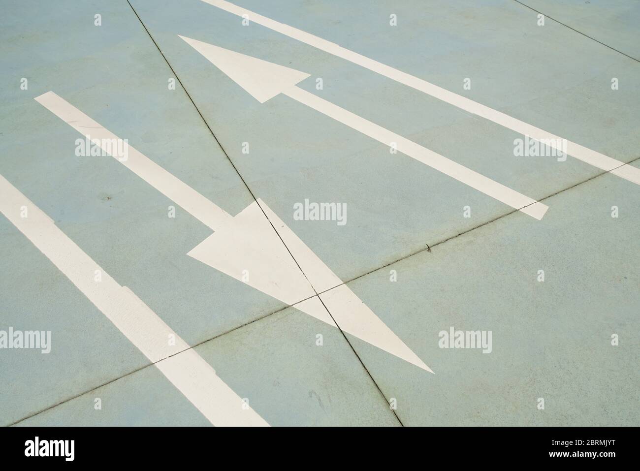 Arrow signs on bike track in the city center Stock Photo - Alamy