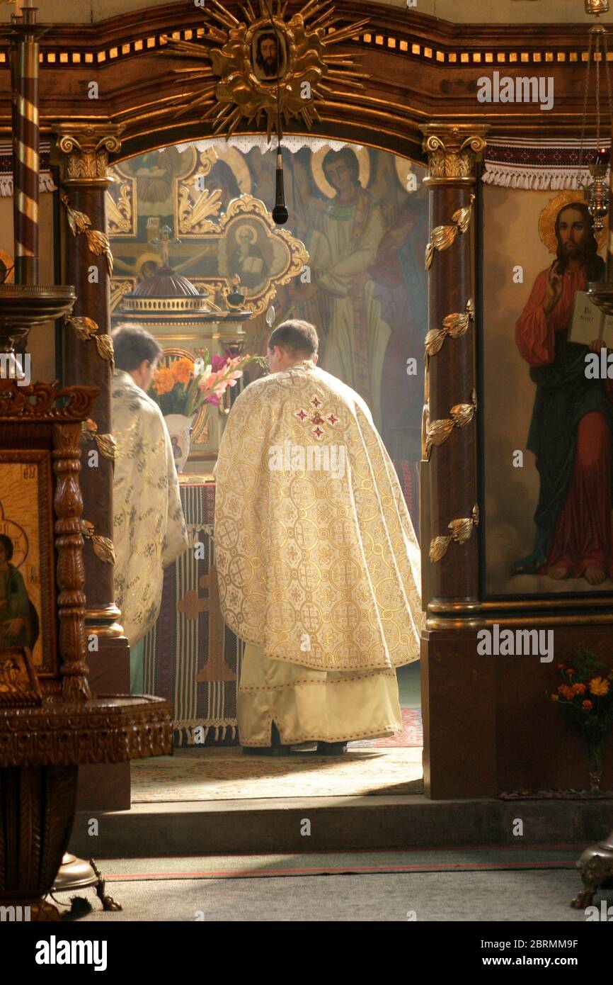 Gura Raului, Romania. The priest during the service inside the ...