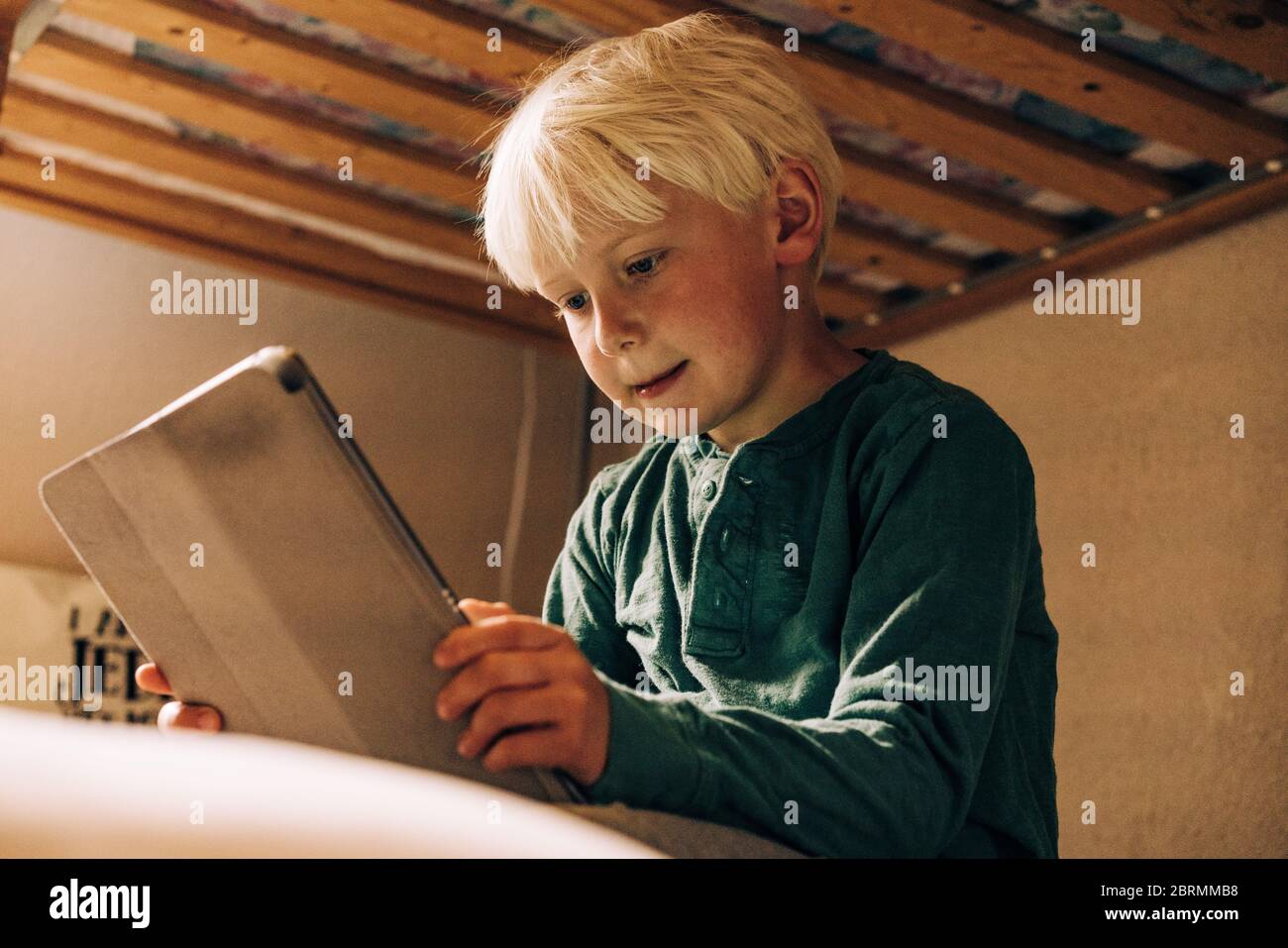 Young boy working on technology Stock Photo - Alamy