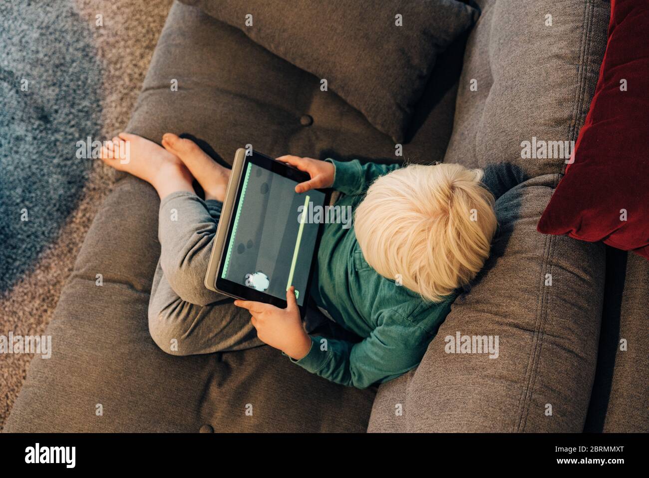 Young boy doing school work on tablet Stock Photo - Alamy