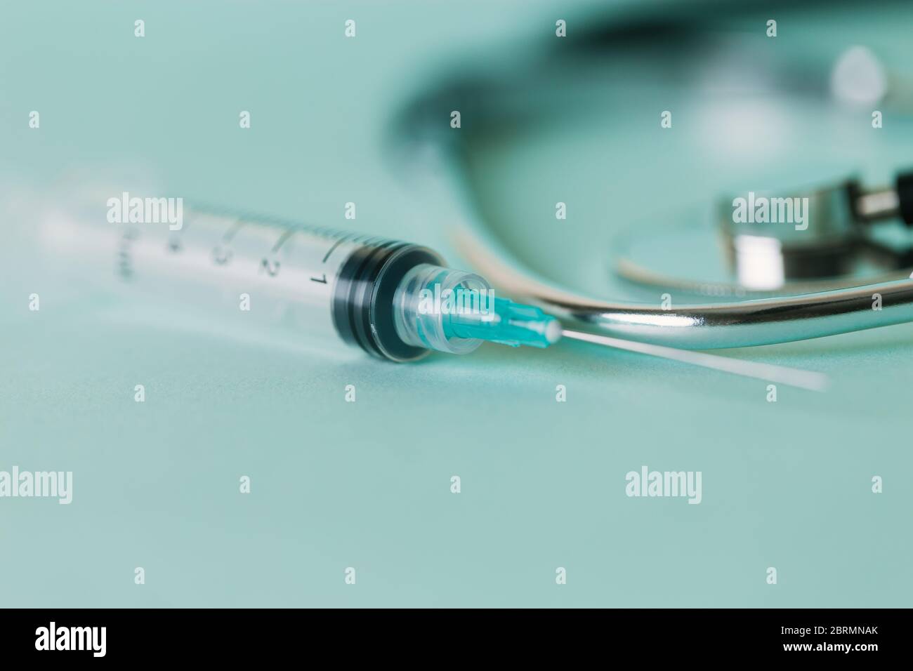 One single brand new sterile syringe next to a stethoscope Stock Photo ...
