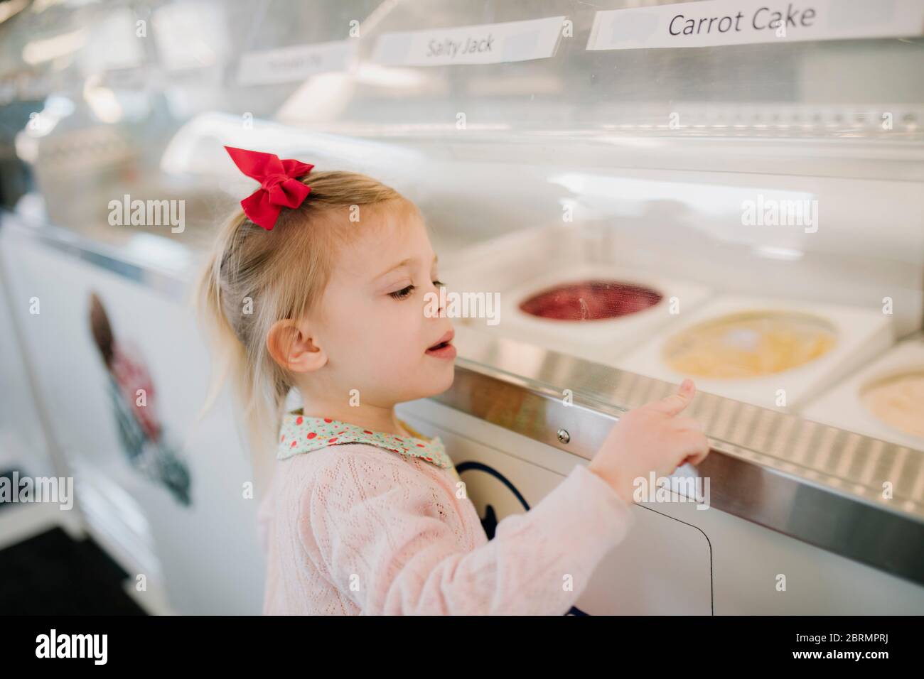 Girl pointing to ice cream Stock Photo - Alamy
