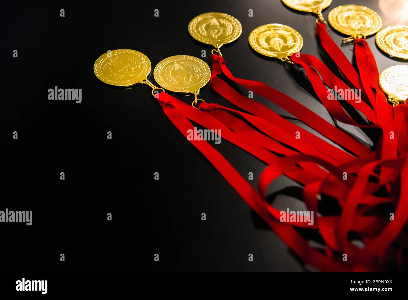 Many gold medals on a table for the victors of their challenges and ...