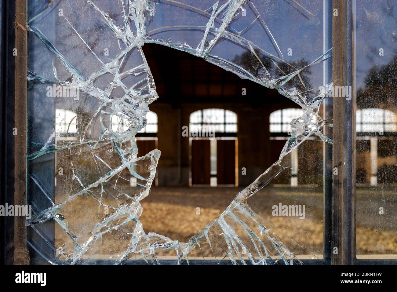 Stoned window with broken glass of an industry Stock Photo - Alamy