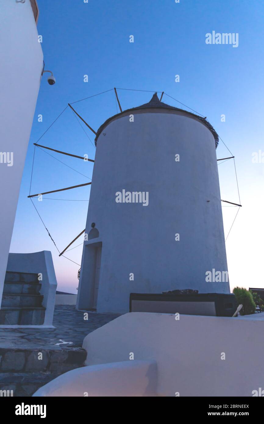 Backside of Greek wind mill during blue purple lightened dusk, Oia ...