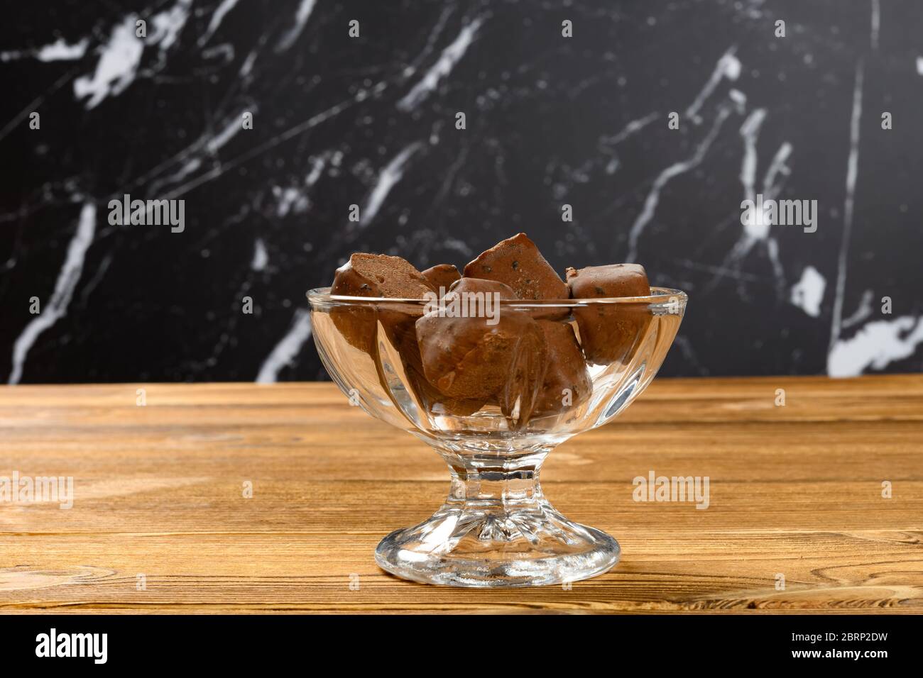 side view cup of fresh chocolate ice cream blocks on a wood table Stock ...