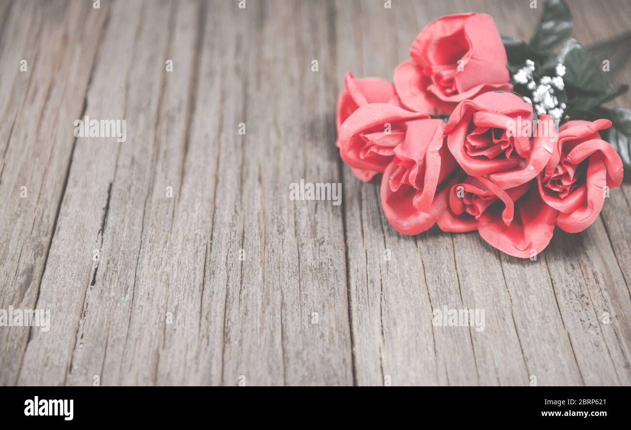 a bunch of rose on the wooden table top ,Ready for display montage,for ...