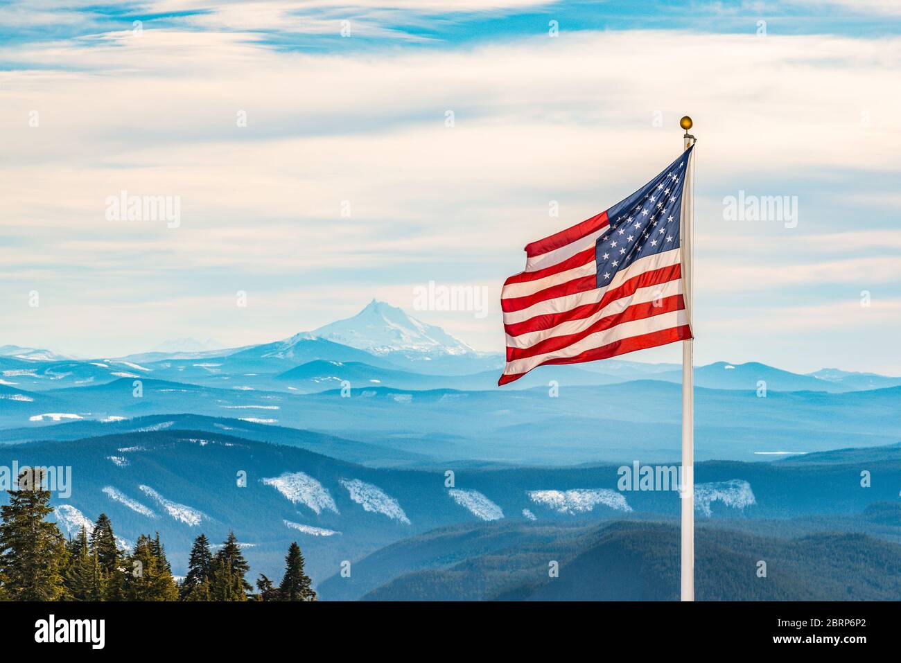 American flag over the peak of snow mountain Stock Photo - Alamy