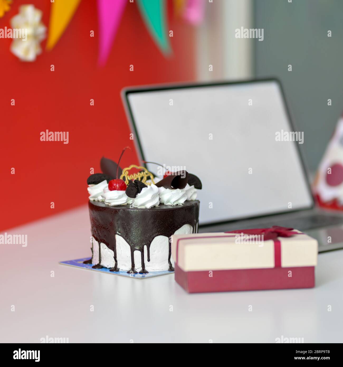 Online Birthday celebration concept with blank screen laptop, cake and ...