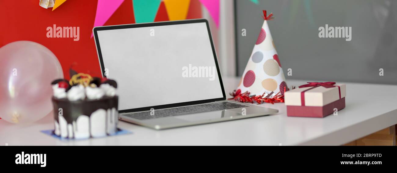 Online Birthday celebration concept with blank screen laptop, cake and ...
