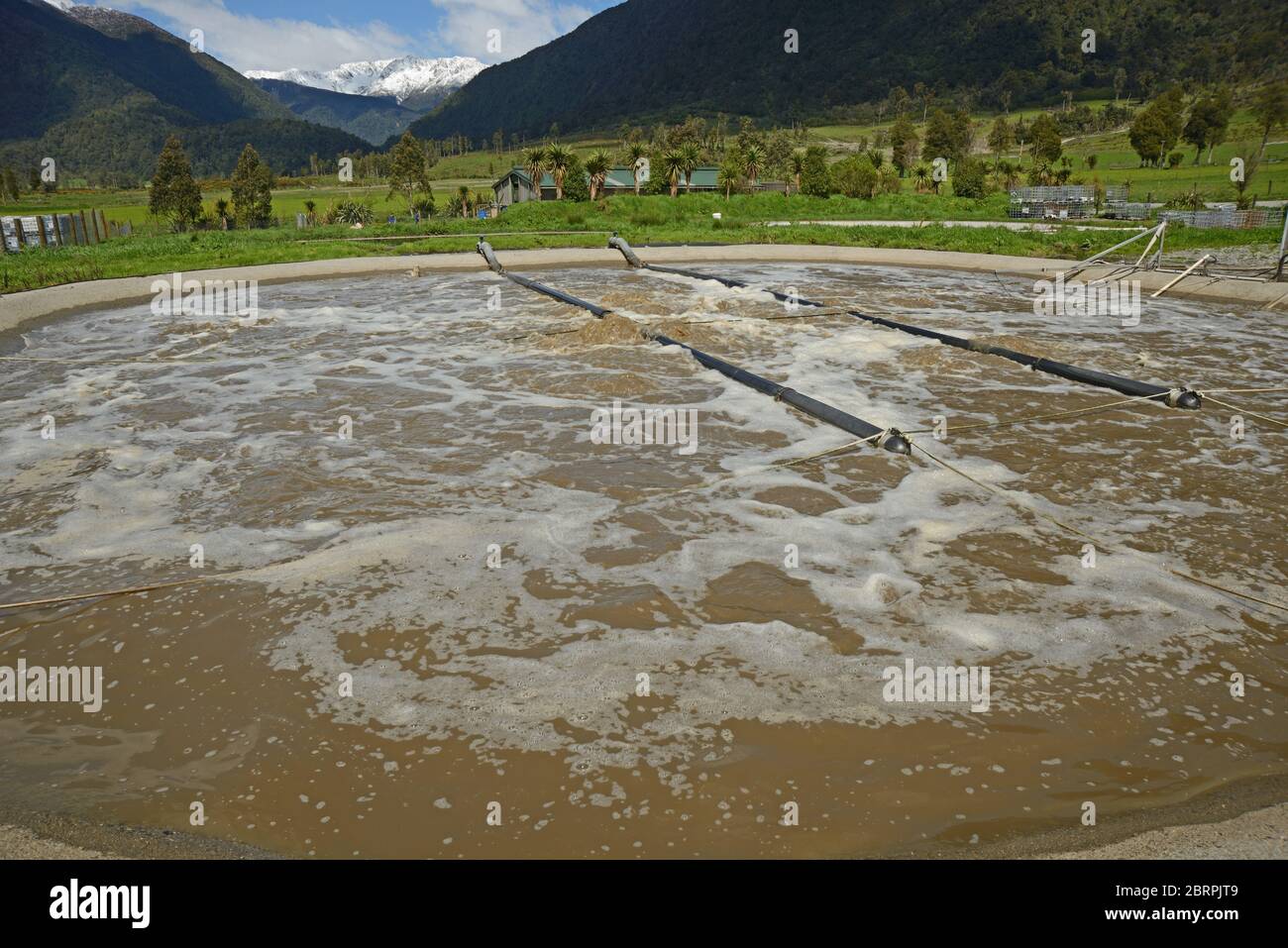 A holding pond uses aeration to remove pollutants from industrial waste ...